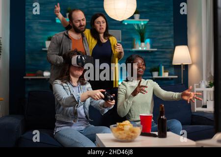 Sad woman gamer wearing virtual reality headset losing space shooter ...