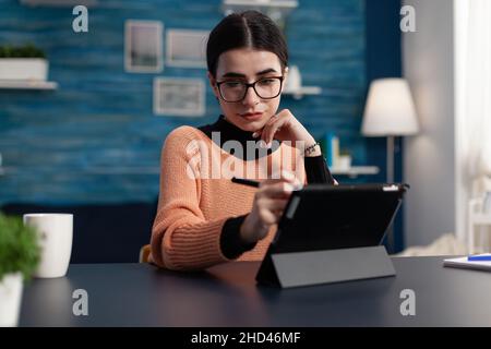 Freelancer holding tablet PC at home Stock Photo - Alamy