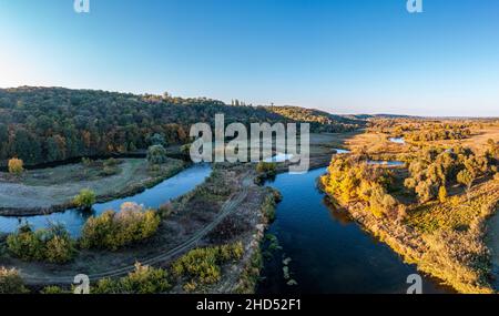 Country ground road stretching between green meadows and long narrow ...