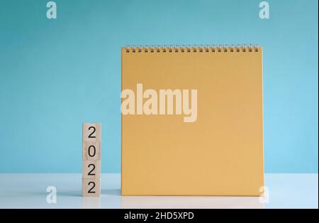 2022 Start word on yellow note with Businessman holding pen and ...