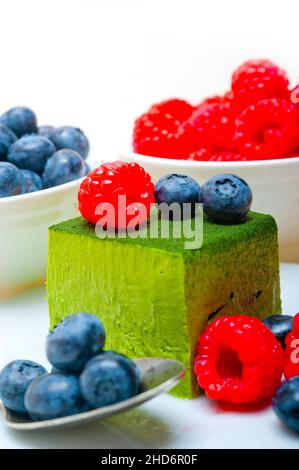 green tea matcha mousse cake with raspberries and blueberries on top ...