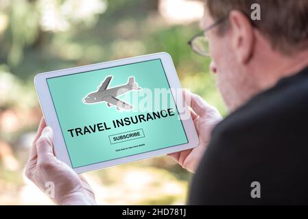 Tablet screen displaying a travel insurance concept Stock Photo - Alamy