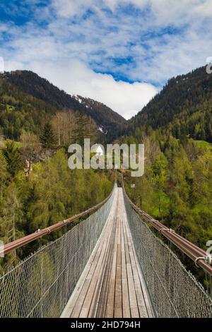 Suspension bridge over deep gorge on a fine morning in summer near ...