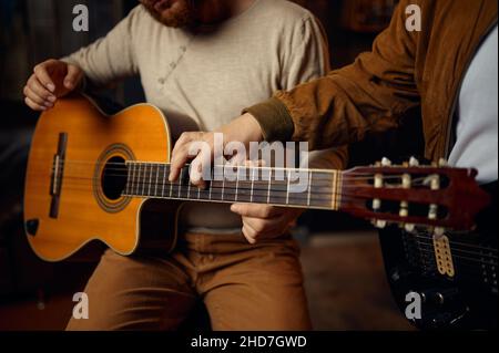 Closeup musician tutor hand showing guitar chord on fingerboard for ...