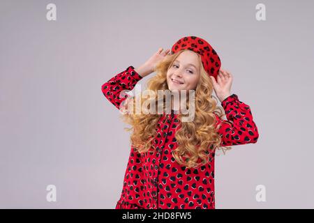 French fashion icon. Happy child wearing french red beret and dress on ...