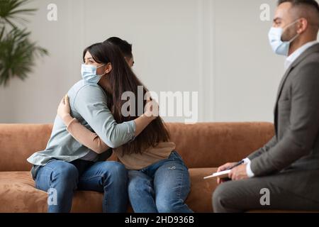 Happy couple hugging reconciling at therapy session in therapists ...