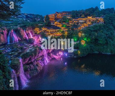 Evening view of Furong Zhen town and waterfall, Hunan province, China ...