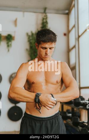 Young Spanish muscular male athlete training in a gym. The concept of ...