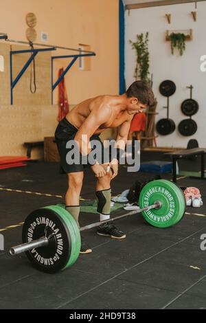 Young Spanish muscular male athlete training in a gym. The concept of ...
