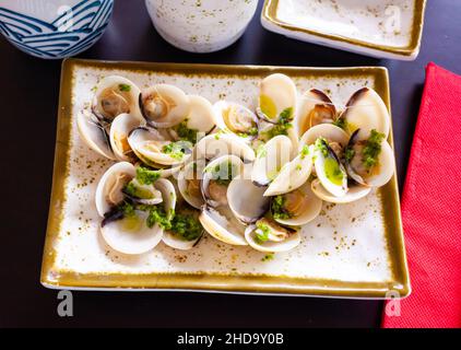 Japanese sake steamed clams with garlic and green onions Stock Photo ...