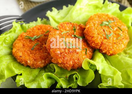 Closeup of a plate with cutlets and salad. Vegan food, veggie snacks ...