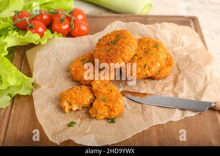 Board with tasty lentil cutlets on grey background Stock Photo - Alamy