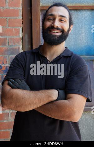 Vertical shot of a Hispanic male posing in a city in a face mask Stock ...