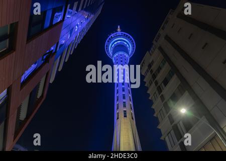 NIght scene tall circular tower illuminated blue Stock Photo - Alamy