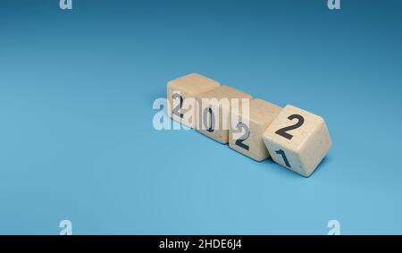 Flipping wooden cubes with the Year number 2022 and 2023 on a magenta ...