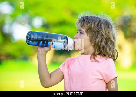 Sporty boy drink water from sport bottle. Fitness kids, health and ...