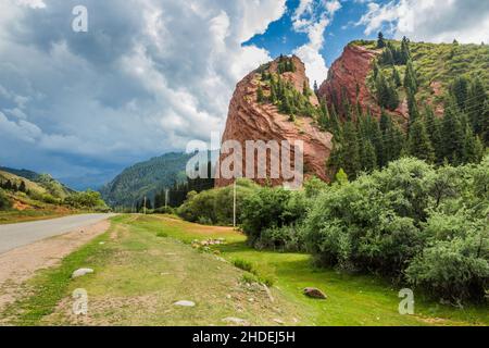 Rock Broken Heart in the Jeti Oguz gorge Kyrgyzstan with white yurts in ...