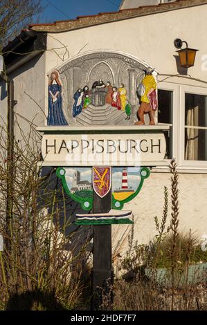 The Happisburgh village sign, depicting figures and landmarks from the ...