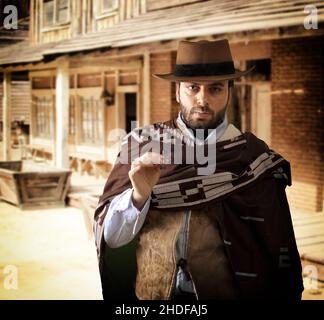 Cowboy with a cowboy hat smoking a cigarette Stock Photo - Alamy