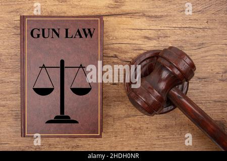 Code of law with judge's gavel - Weapons law Stock Photo - Alamy