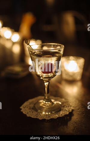 A cocktail on a sidetable by candlelight Stock Photo - Alamy