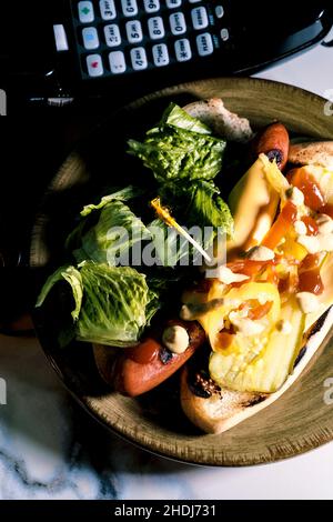 The works hot dog with retro landline corded phone in the background ...