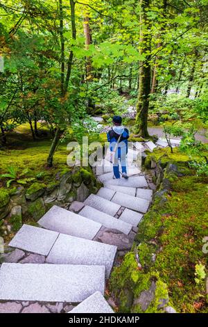 Tourist exploring hand crafted stone steps; Portland Japanese Gardens ...