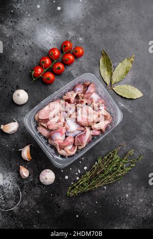 Raw chicken gizzards market plastic pack set, on gray stone table ...