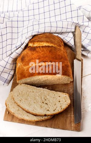 Vertical shot of bread slices on a bowl isolated on brown background ...