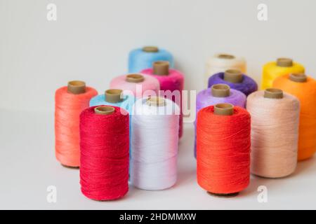 Colorful thread rolls on white background Stock Photo - Alamy