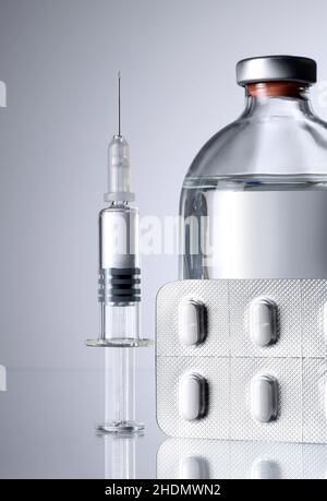 Medical bottles syringe and tablets on light gray background Stock ...