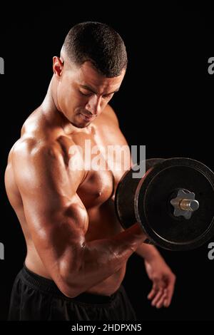 side view - the sports guy - a bodybuilder in jeans and a t-shirt on a ...