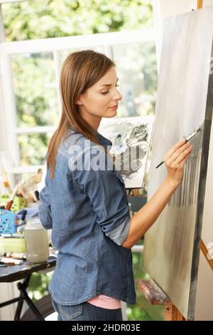 Female artist with color palettes drawing in workshop Stock Photo - Alamy