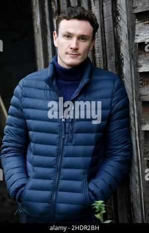 young guy wear winter jacket. guy in winter jacket outdoors. stylish ...