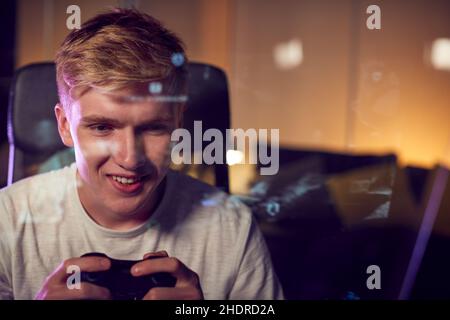 teenage boy computer nerd playing on computer in messy room surrounded ...