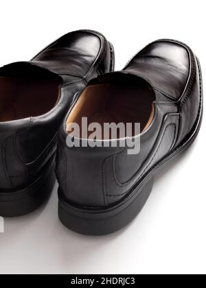 A vertical shot of a pair of black shoes on a white surface Stock Photo ...