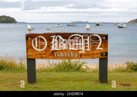 The town sign of Oban sits on the beachfront, and on top of the sign ...