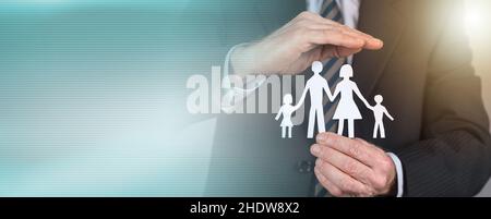 Insurer protecting a family with his hand; panoramic banner Stock Photo ...