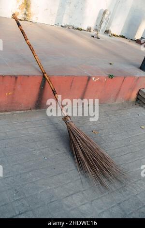 Close up broom worker cleaning dirty footpath Stock Photo - Alamy