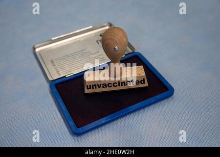 on the wooden stamp is the word unvaccinated Stock Photo - Alamy