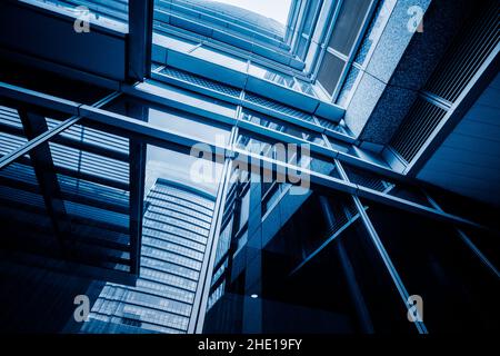 Commercial building close up in blue tone. Gigantic skyscraper from ...
