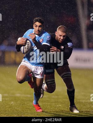 Gloucester's Santiago Carreras (left) is tackled by Harlequins' Dino ...