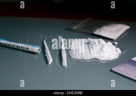 Envelope, pile and rolled banknote. Cocaine divided into strips on a ...