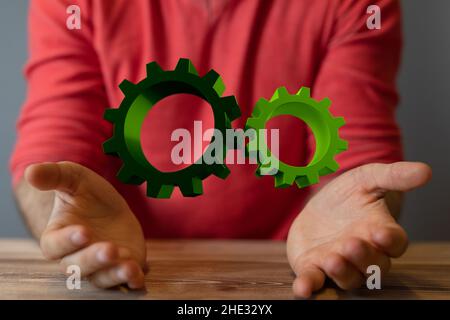 Businessman holding a digital render of a green world map- environment ...