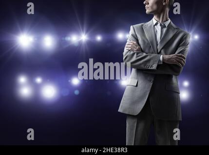 Confident businessman in bokeh lights Stock Photo - Alamy