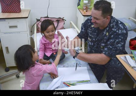 Sailors from the USS Frank Cable volunteer at a hospital in Kota ...