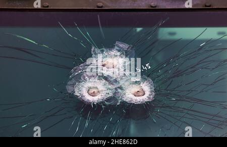 Armored glass after of a direct hit from an automatic weapon. Safety ...