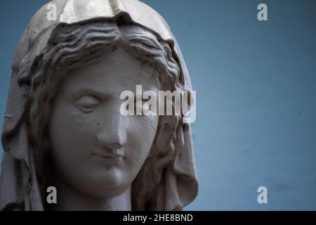 Closeup shot of Virgin mary's face statue on a blue background Stock ...