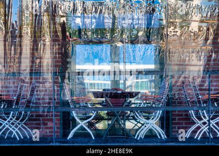 Terrace of a restaurant behind a plastic tarpaulin Stock Photo - Alamy