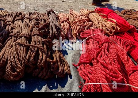 Close up shot of heap of braided hemp ropes made for sale at outdoor ...